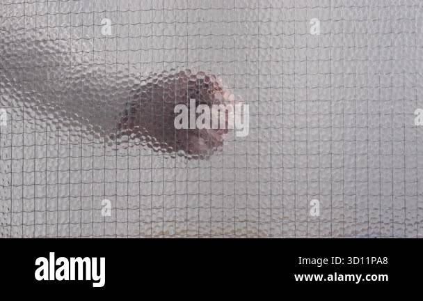Mysterious female hand knocking on glass window , visitor or guest or ...