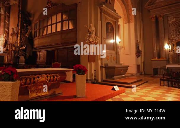 Baroque church altar illuminated in warm golden light with ornate ...