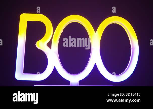 Colorful boo sign shines brightly at a Halloween event, surrounded by ...