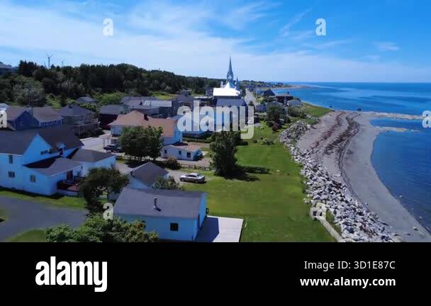 Flying over the small village of Saint-Ulric-de-Matane along its beach ...