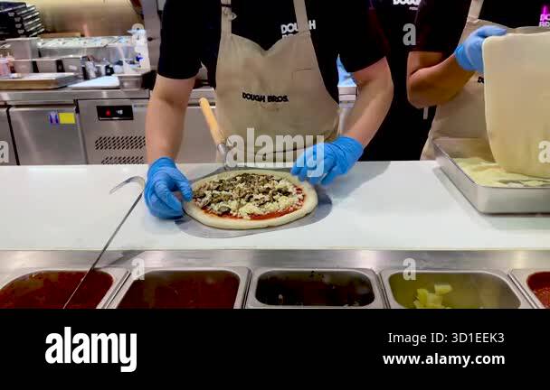 Chefs preparing pizza with teamwork and precision Stock Video Footage ...