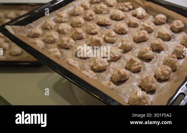 Baking tray filled with golden cookies or chicken meatball ready to ...