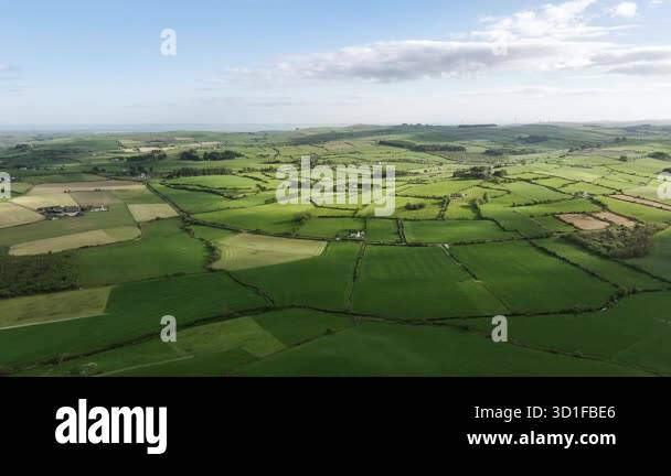 Fly over the beautiful Irish countryside. Green pastures and farmland ...