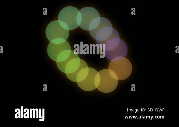 Abstract circular bokeh lights displaying a spectrum of colors against ...