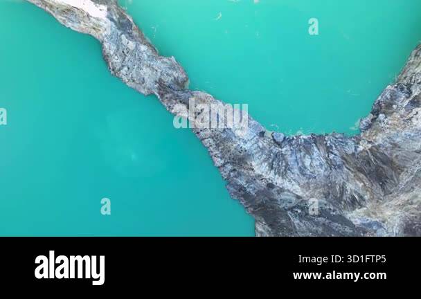 Close up of turquoise volcanic water reveals vibrant mineral colors and ...