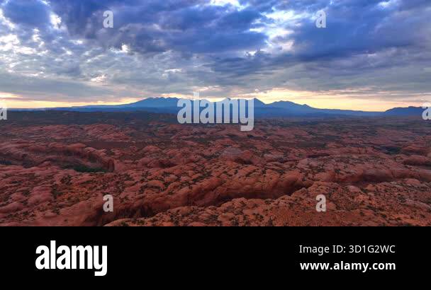 Grey cloudscape accumulated in the sky over the dry rocky landscape ...