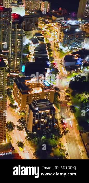 Aerial nighttime view of Honolulu, Oahu. Illuminated streets, high-rise ...