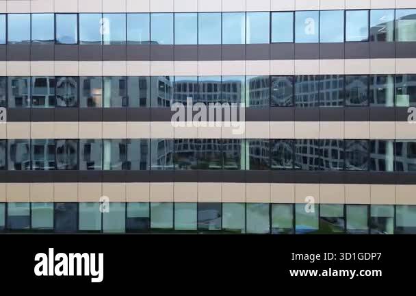 Modern office building exterior showcasing sleek glass facade, camera ...