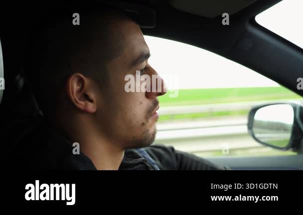 Male driver focused on the road, showcasing a seamless transition of ...