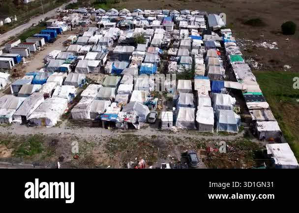 An aerial view of a makeshift migrant camp.Shacks constructed from ...