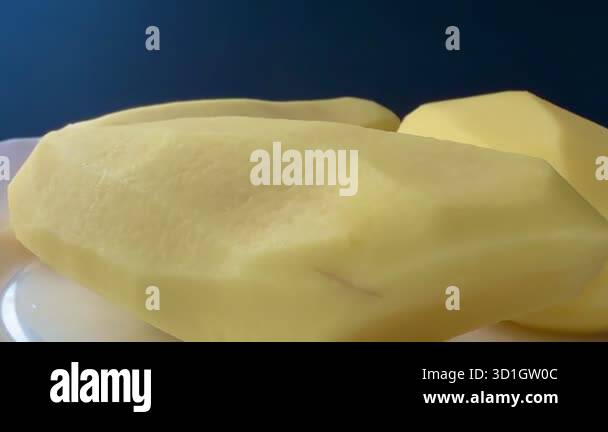 A close-up of a raw, peeled potato. Vegetarian and vegan food Stock ...