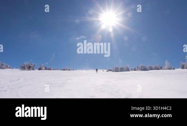 Enjoy a thrilling run down snowy slopes as the sun shines brightly in a ...