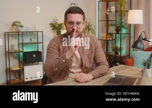 Shh be quiet please. Caucasian young businessman presses index finger ...