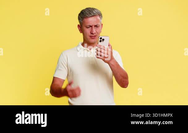 Middle-aged man angrily yelling into smartphone during phone call ...