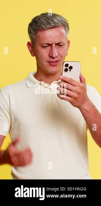 Middle-aged man angrily yelling into smartphone during phone call ...