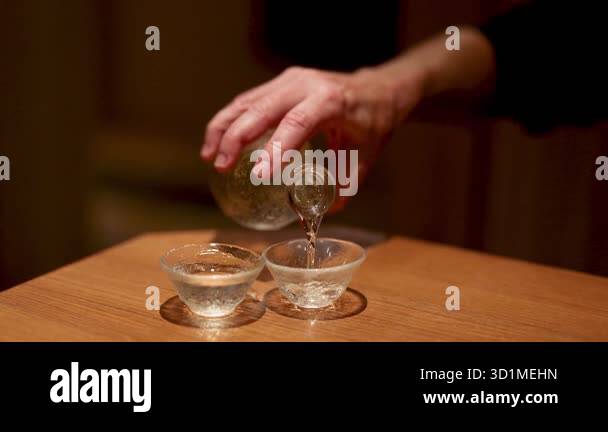 Sequence of pouring clear liquid into small cups Stock Video Footage ...