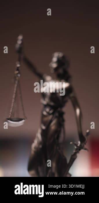 vertical video of bronze law statue represented by blindfolded goddess ...