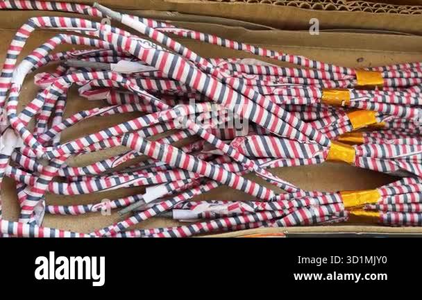 striped red blue white firework ladi crackers arranged in cardboard box ...