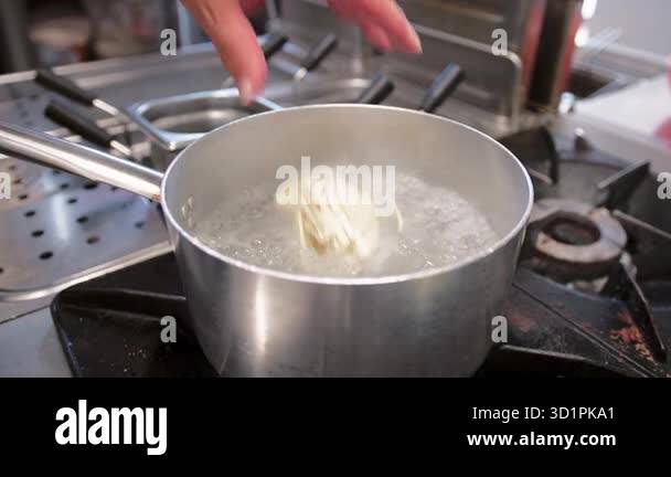 Chef Putting Pasta Inside Boiling Water Pot Stock Video Footage - Alamy