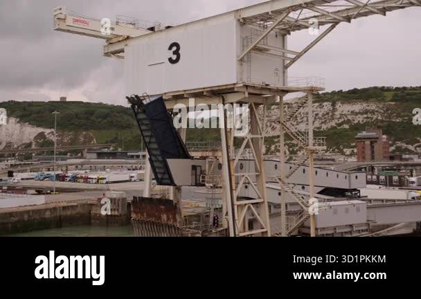 Pan across the Port of Dover from aft of ferry. White cliffs are in ...