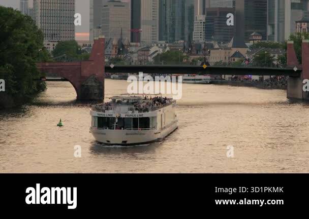 Close clip of a Main River tour boat with the Frankfurt skyline behind ...