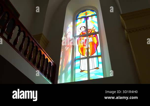 Vibrant stained glass windows bathed in light, depicting figures of ...