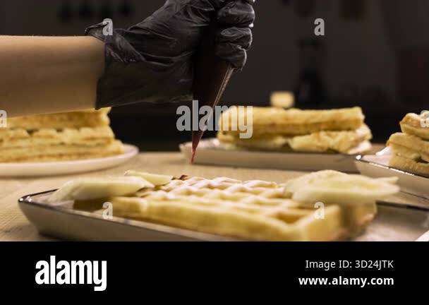 Belgian waffles sprinkling with chocolate topping, top view. Chef ...