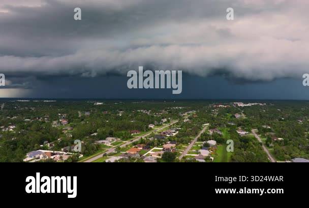 Strong rain shower from storm clouds over Florida neighborhoods ...