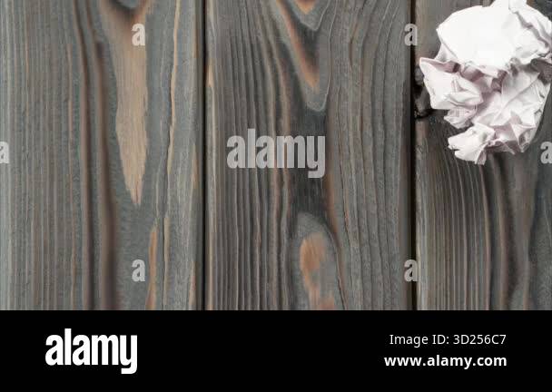 Little white crumpled structure paper rolling and unfolding with red ...