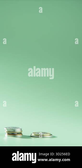 Three stacks towers of different coins appearing on green background ...