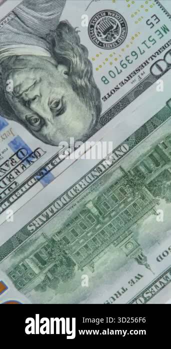 Pile of one hundred 100 dollars banknotes bills changing positions ...