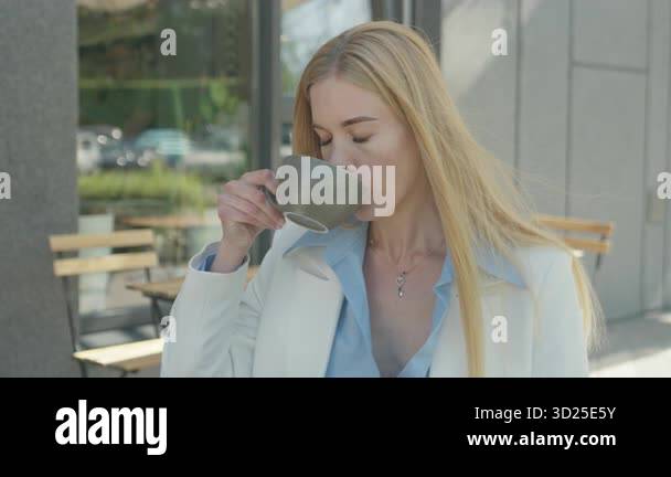 Relaxed Blonde Woman Enjoying Fresh Coffee On Windy Morning Terrace ...