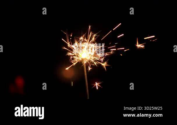 Close up of Bengal fire burning with bright golden sparks against the ...