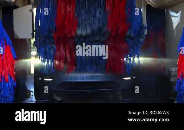 POV shot of the car washing in an automatic car wash tunnel with ...