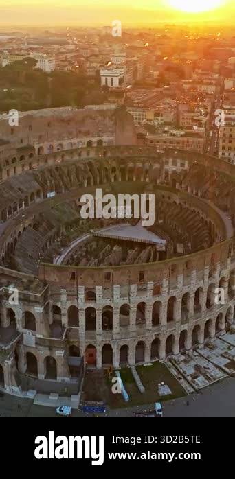 Aerial view of iconic ancient Arena of Colosseum at sunset. Flavian ...