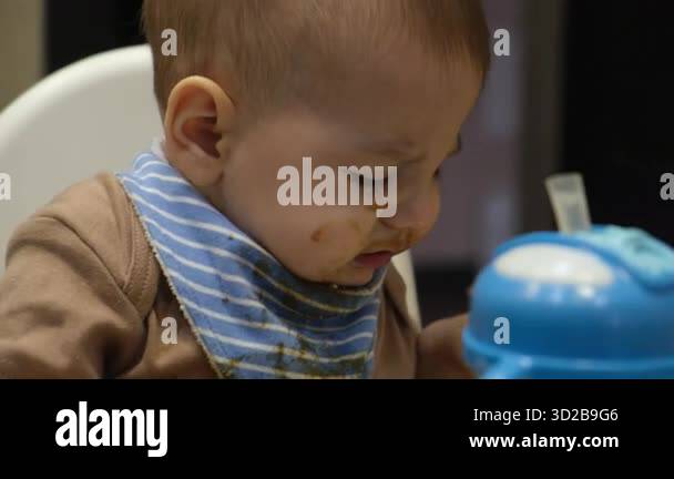 Baby with Food-Stained Face in High Chair Close up Stock Video Footage ...