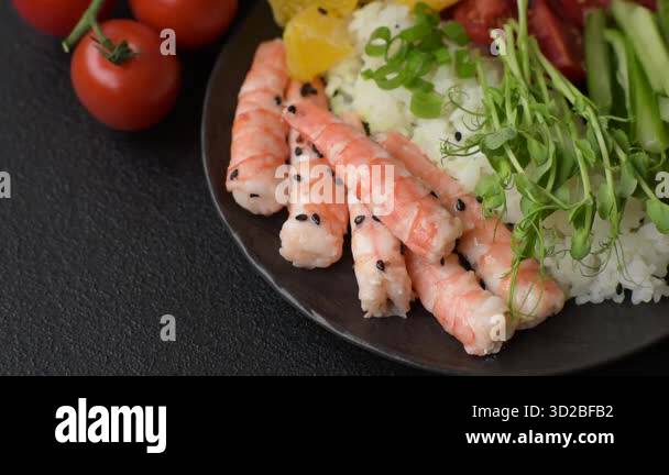 A prawn or shrimp bowl with rice, tomatoes, sauce, and vegetables ...