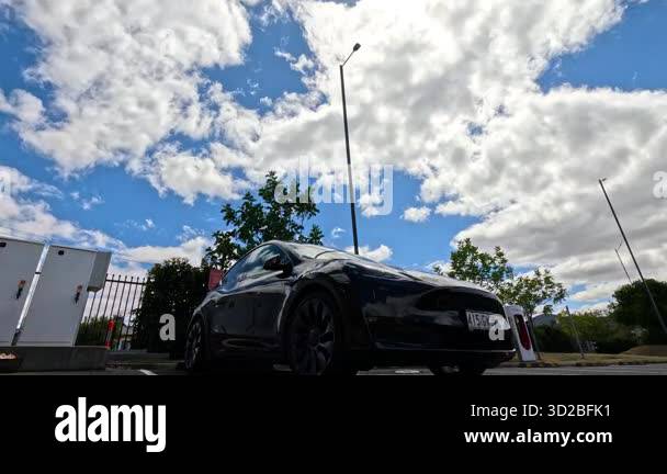 EV parked as clouds drift overhead Stock Video Footage - Alamy