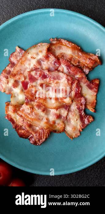 Cooked crispy fried pork bacon strips for a hearty breakfast. Fried ...