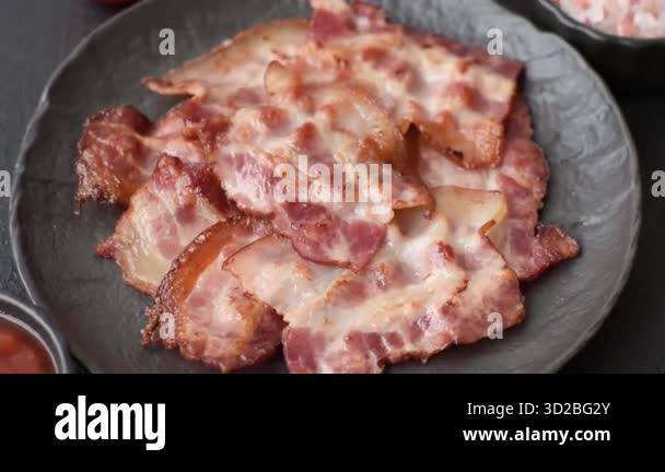 Cooked crispy fried pork bacon strips for a hearty breakfast. Fried ...