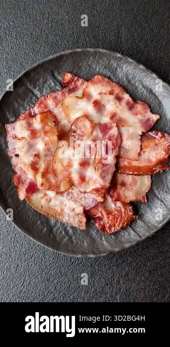 Cooked crispy fried pork bacon strips for a hearty breakfast. Fried ...