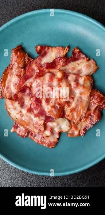 Cooked crispy fried pork bacon strips for a hearty breakfast. Fried ...