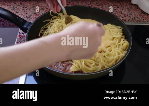 close up chef mixing pasta carbonara ingredients in frying pan Stock ...