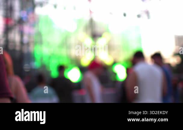 Silhouettes of people clapping and waving at a live music concert at an ...