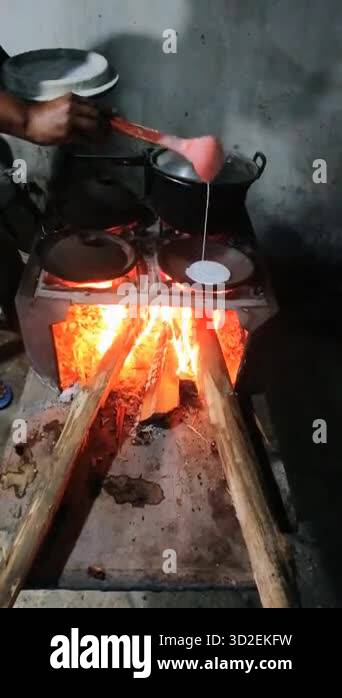 Traditional Sarabi cake being made using rice flour batter, poured onto ...