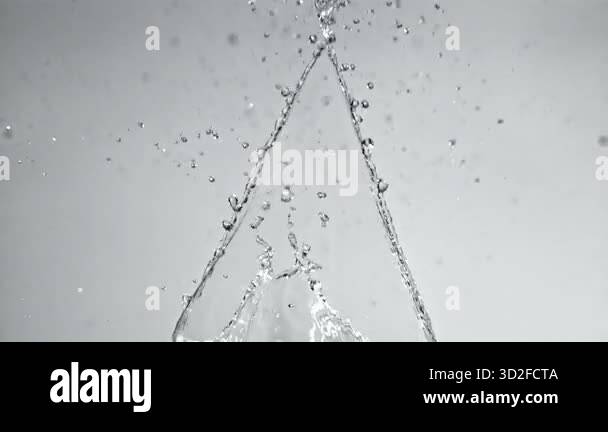 Splashes of water on a light background. Filmed on a high-speed camera ...