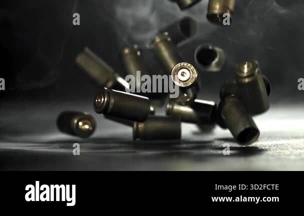 Bullet casings are pressed on the table. Filmed on a high-speed camera ...