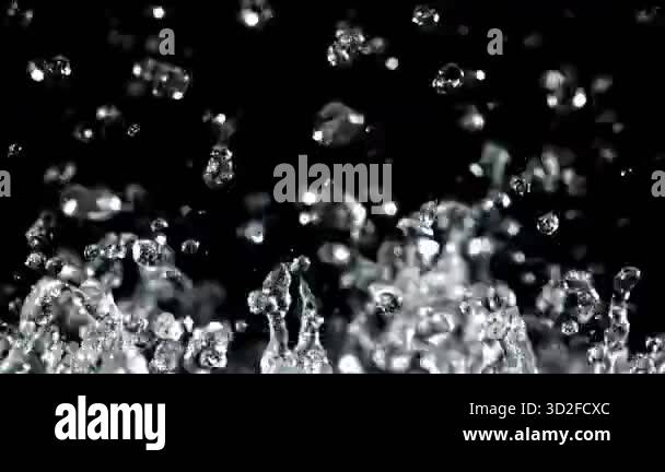 Splashes of water on a black background. Filmed on a high-speed camera ...