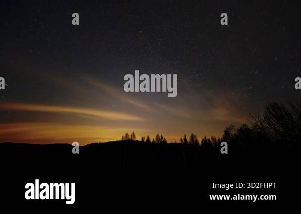 4K time-lapse video of a starry night sky with fast-moving clouds ...