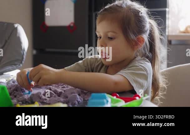 A joyful child engages in creative play with colorful modeling foam ...